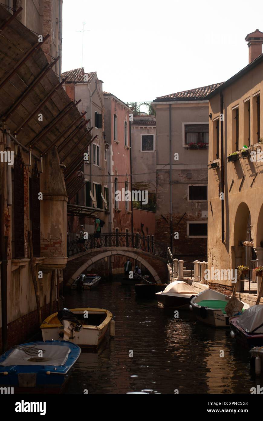 Boats on channel under buildings in old town in sunlight Stock Photo ...