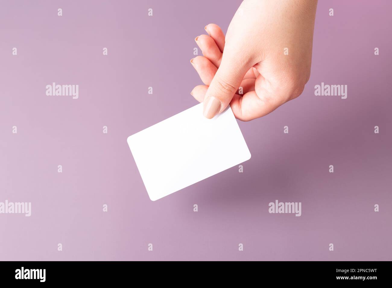 One hand holds an empty advertising card. Background for advertisement ...