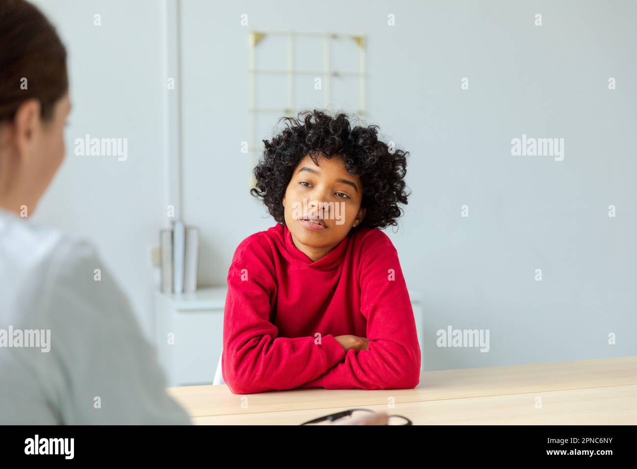 Young african american woman patient and female doctor in doctor office ...