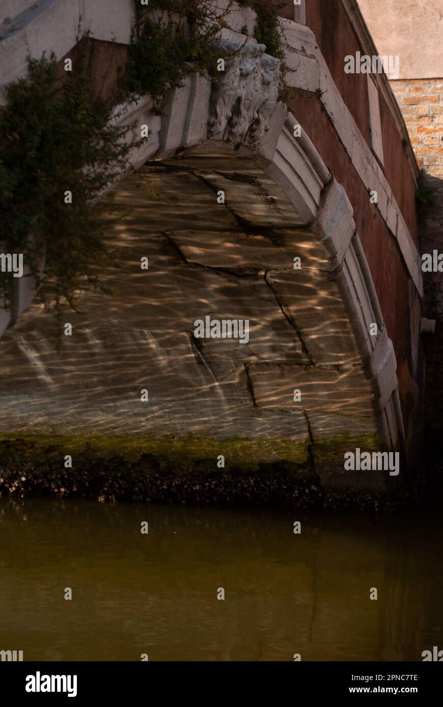 View of reflections of water on brick bridge Stock Photo - Alamy