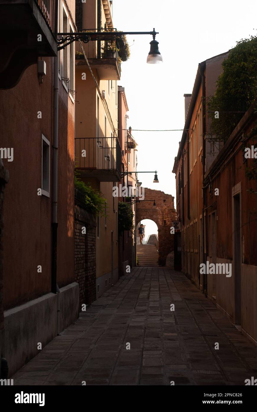 View of arch on a small street with street lamps in sunlight Stock ...