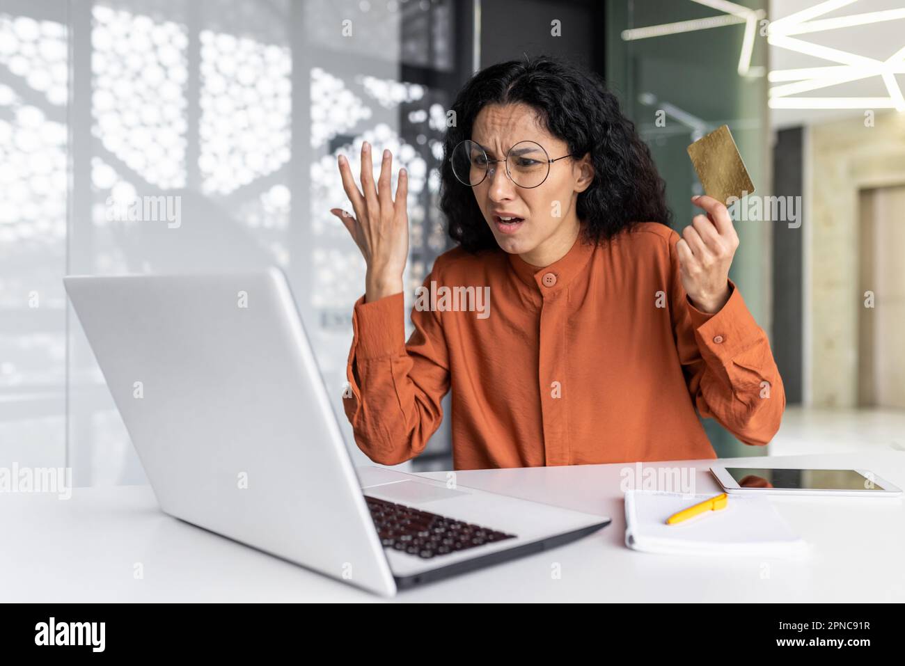 Dissatisfied and angry businesswoman inside the office, hispanic woman at workplace cheated by ...