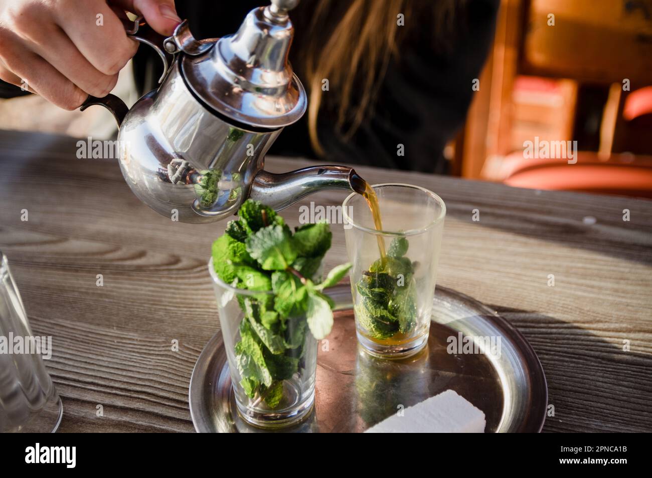 Traditional Moroccan tea pot with a cup outside ready to drink Stock ...