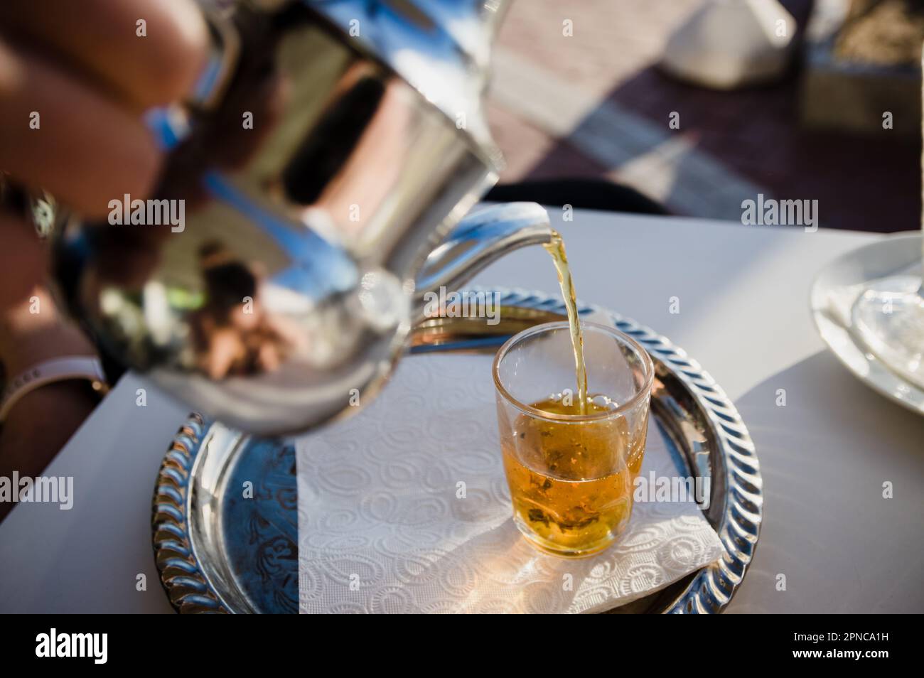 Traditional Moroccan tea pot with a cup outside ready to drink Stock ...