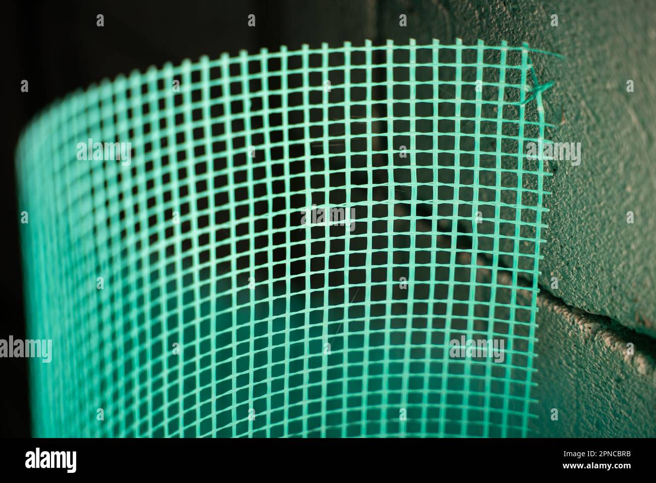 Plastic reinforcing facade mesh in green color close-up. Plaster mesh ...