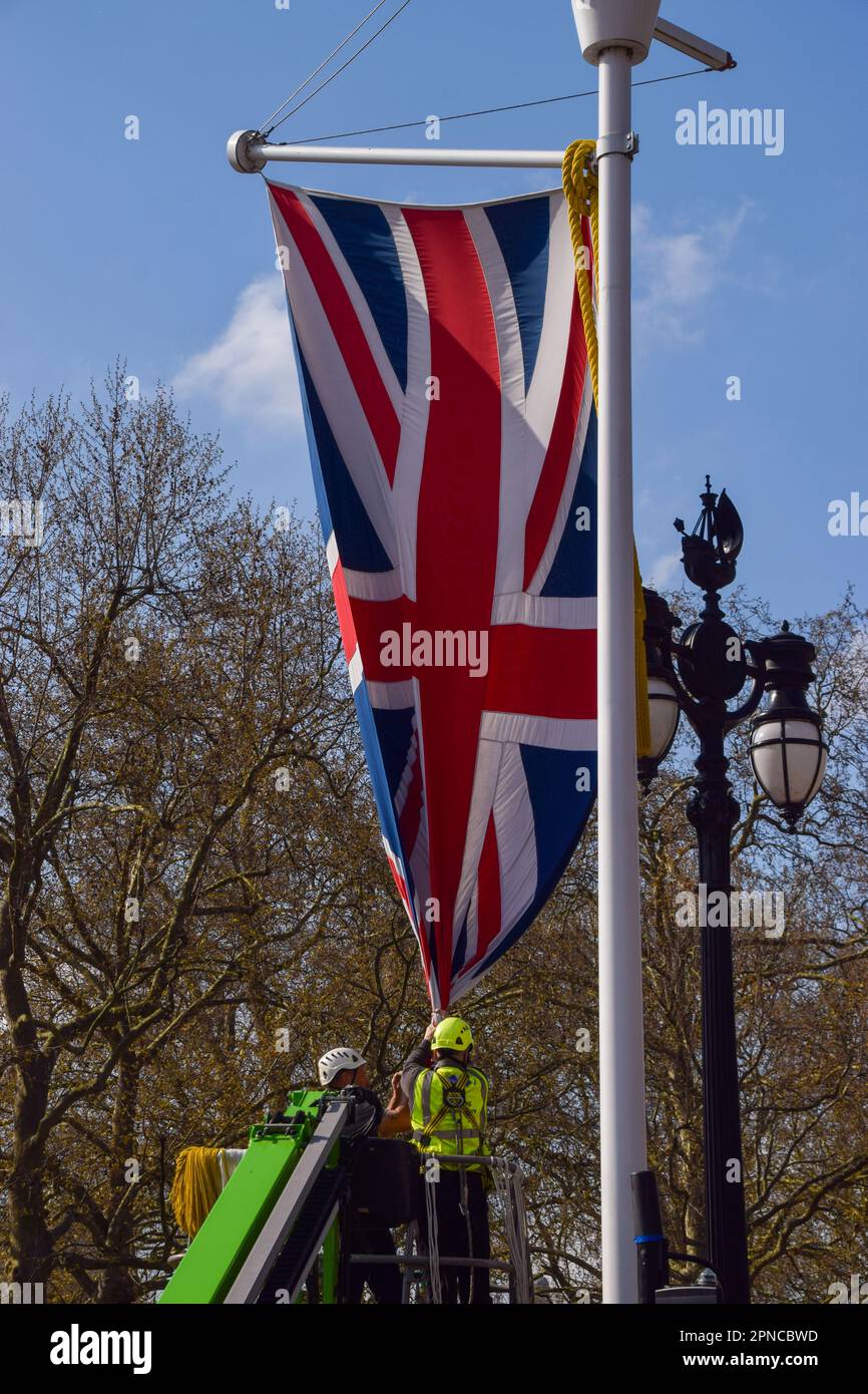 London, UK. 18th April 2023. Workers install Union Jacks in The Mall as ...