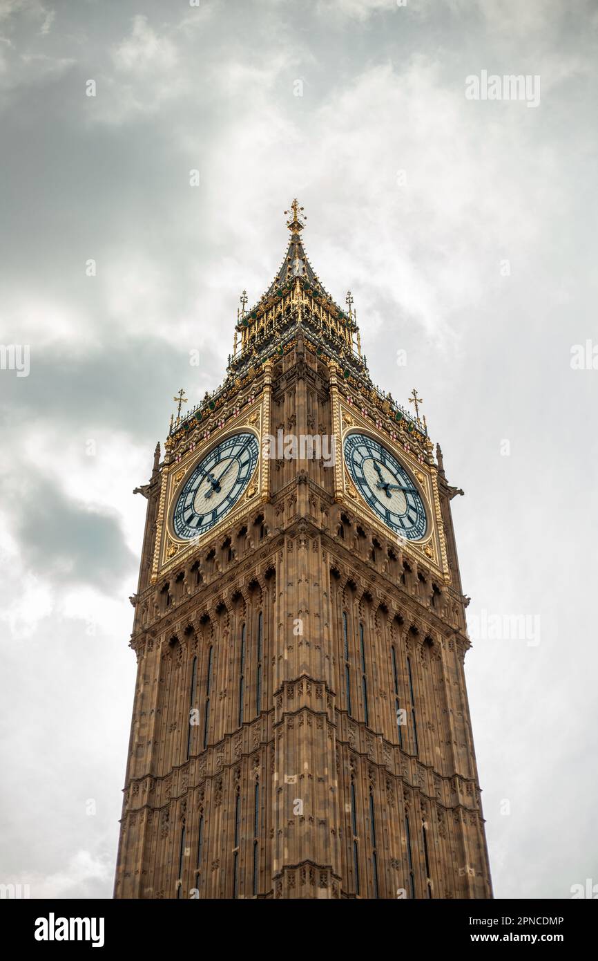 Majestic Big Ben clock tower in London stands tall against a cloudy sky ...