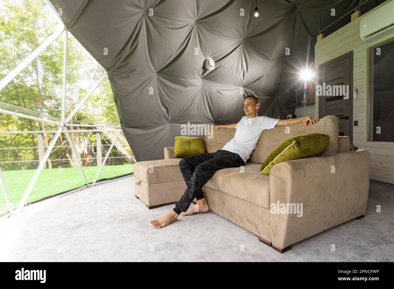 young man resting outside the city in glamping Stock Photo - Alamy