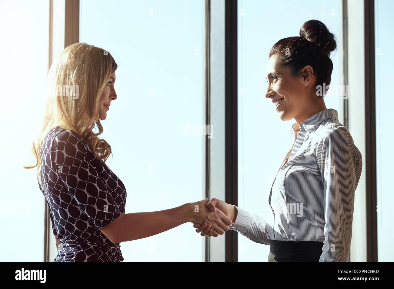 Its nice to finally put a face to the name. two young businesswoman ...