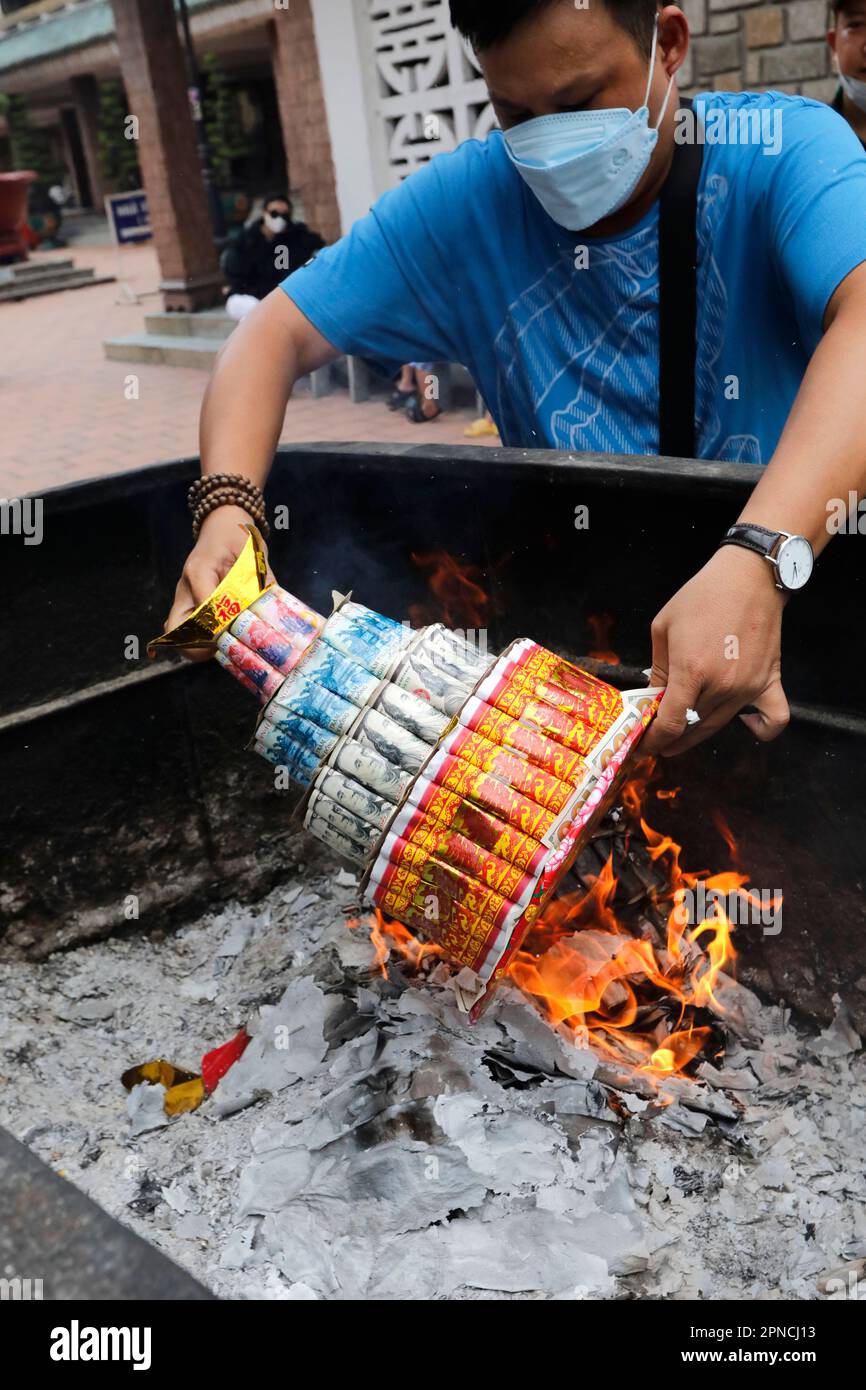 Mieu Ba Chua Xu temple. The temple of the goddess Xu. Man burning joss ...
