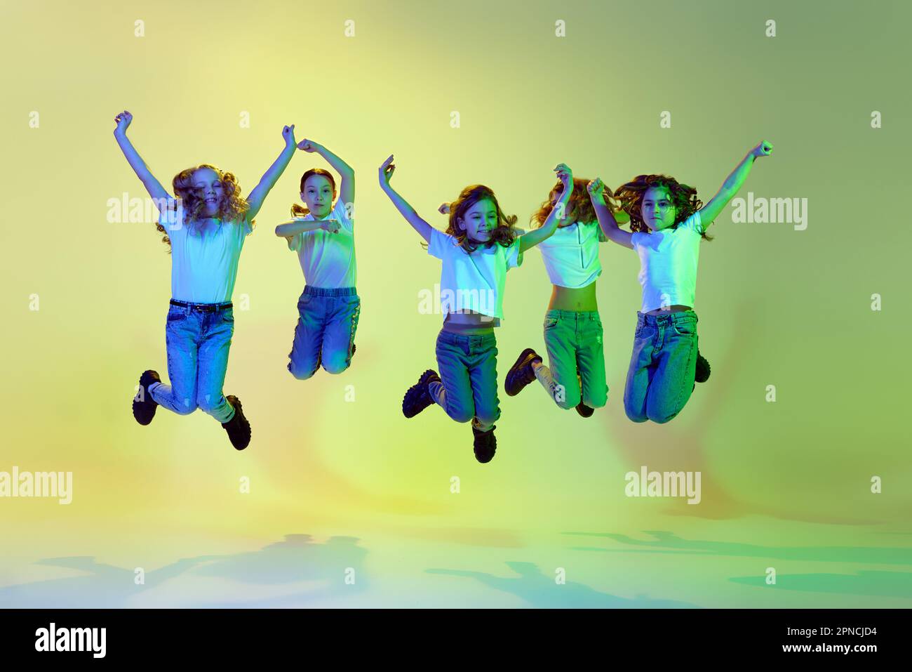Cheerful, happy, little girls, children in casual sporty style clothes ...