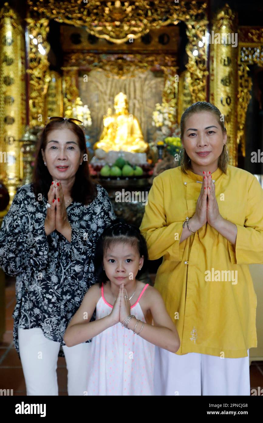 Chua Ho Quoc pagoda. Three generations of women praying together. Phu ...
