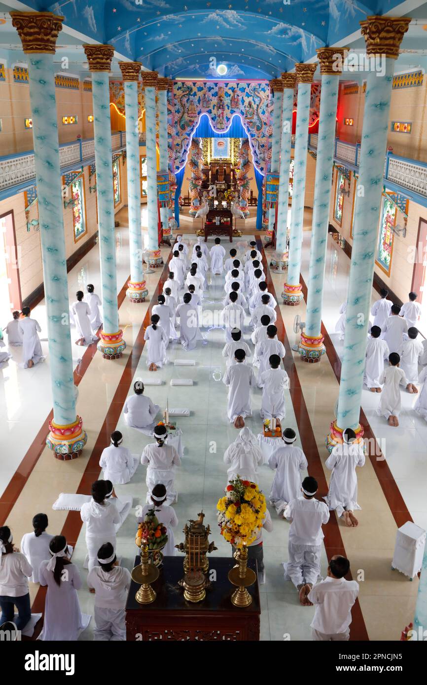 Cao Dai temple. Caodaist worshippers at ceremony. Tan Chau. Vietnam ...
