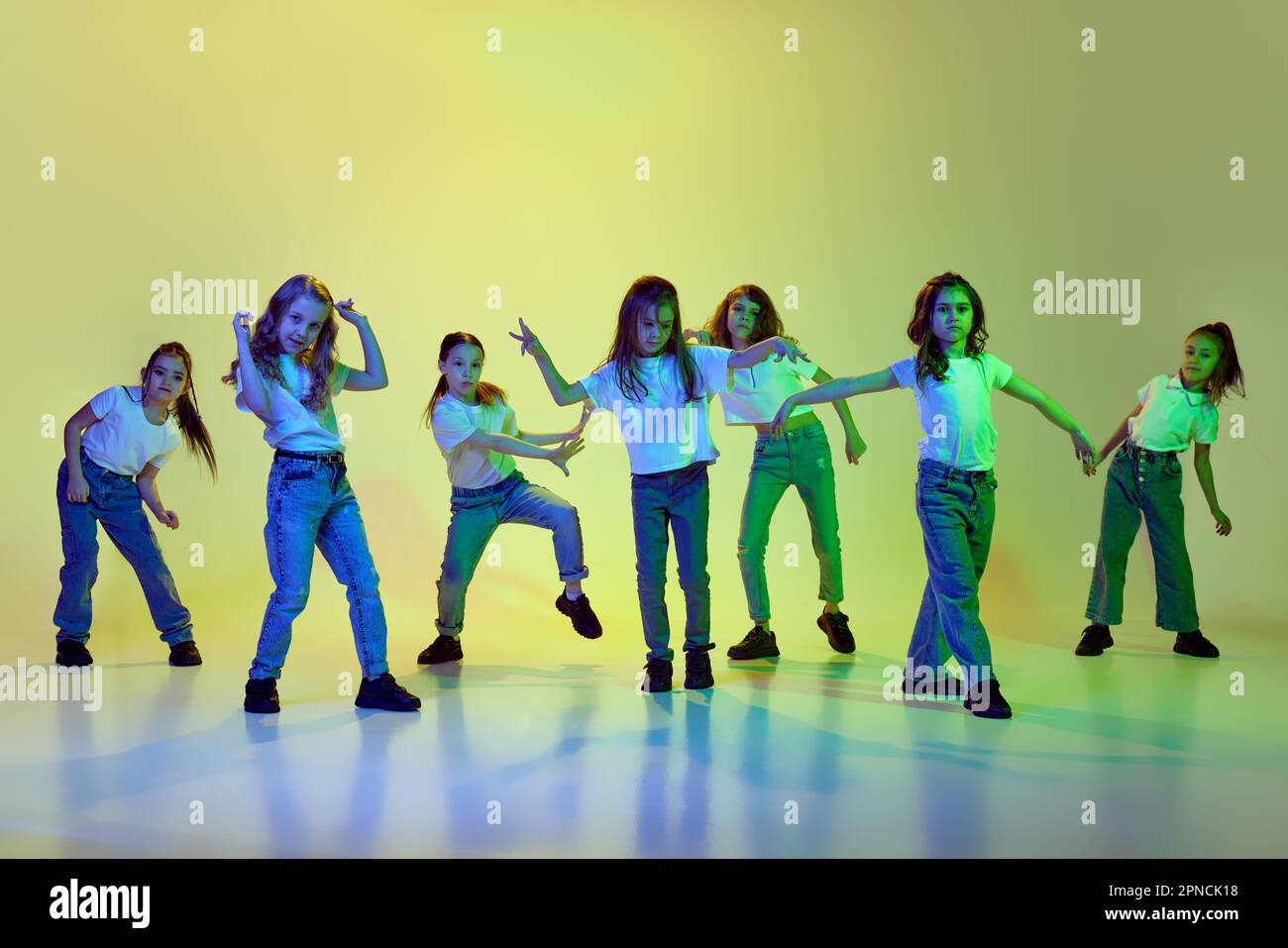 Movements. Little cute girls, children in casual clothes dancing ...