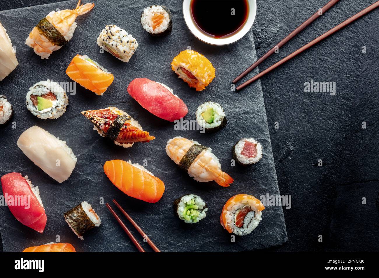 Sushi overhead flat lay shot with chopsticks, soy sauce, and copy space ...
