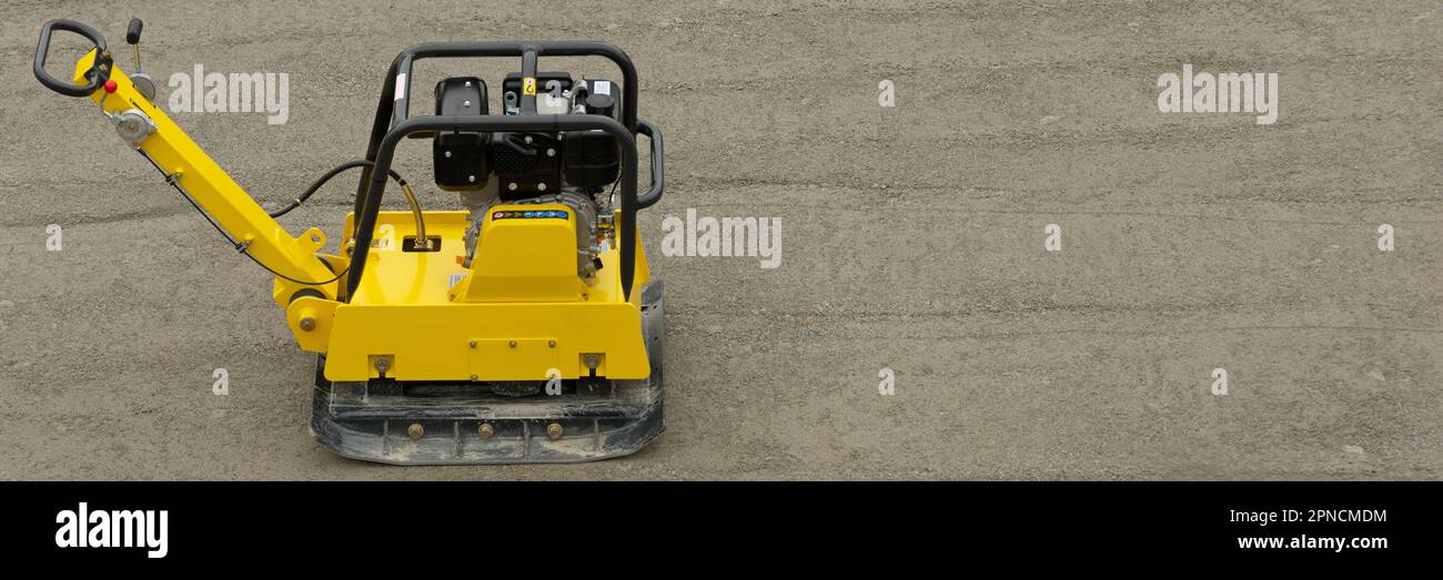 Vibratory plate compacts gravel base layer, banner format Stock Photo ...