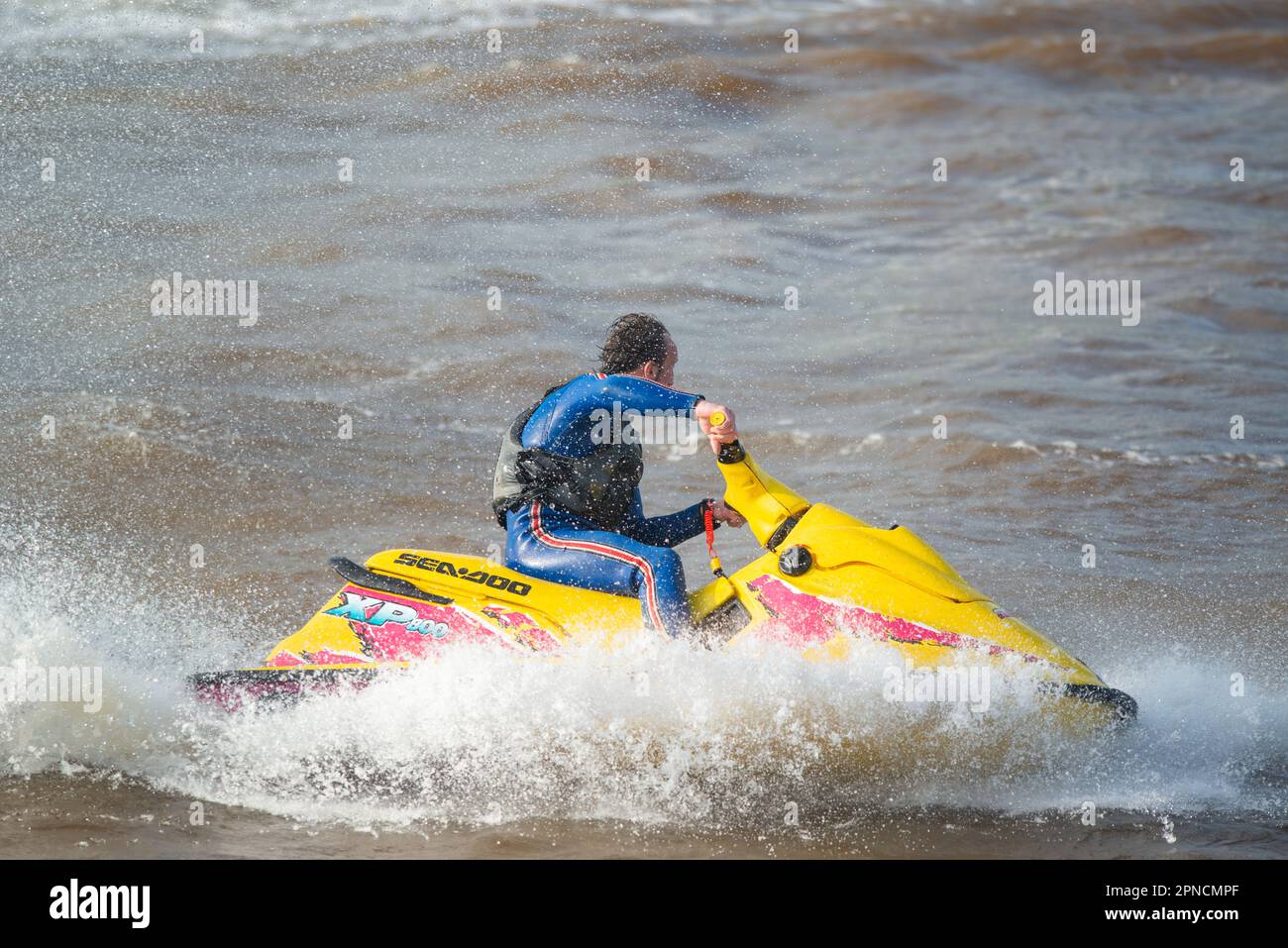 Man on jetski at Kidwelly Quay which is an area rich in bird life Stock ...