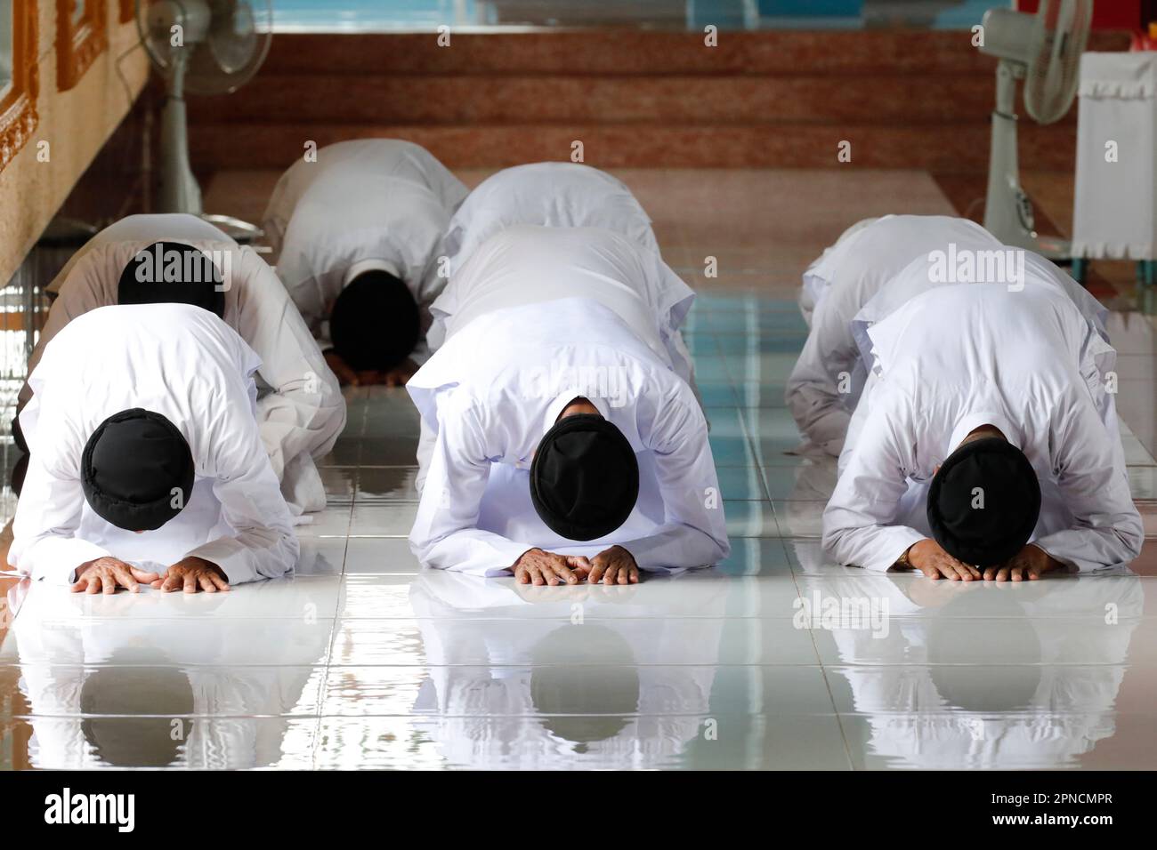 Cao Dai temple. Caodaist worshippers at ceremony. Meditating followers ...