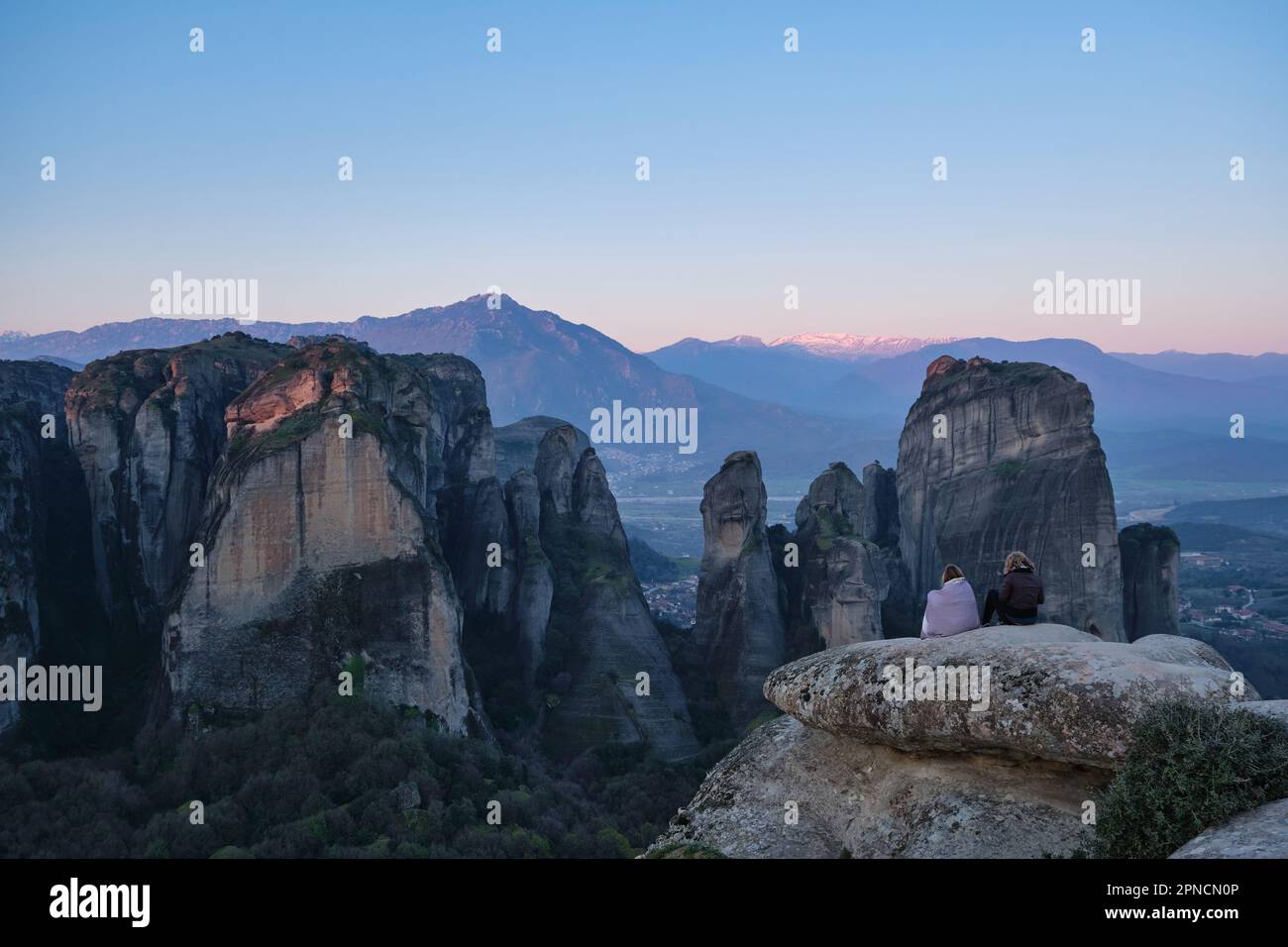 Two female Tourists waiting for sunrise over Meteora in Spring Stock ...