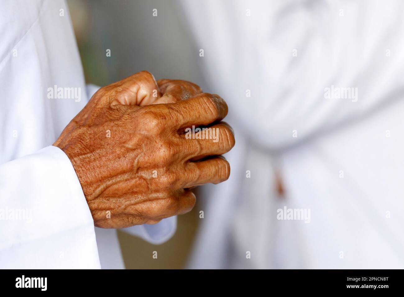 Cao Dai temple. Caodaist service. Man praying. Close-up on hands. Tan ...