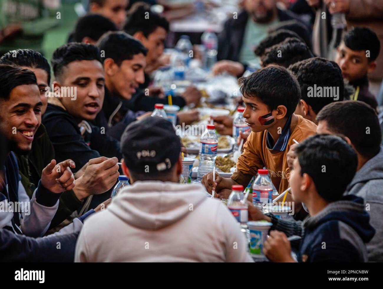 Gaza, Palestine. 17th Apr, 2023. Palestinian families eat a communal ...