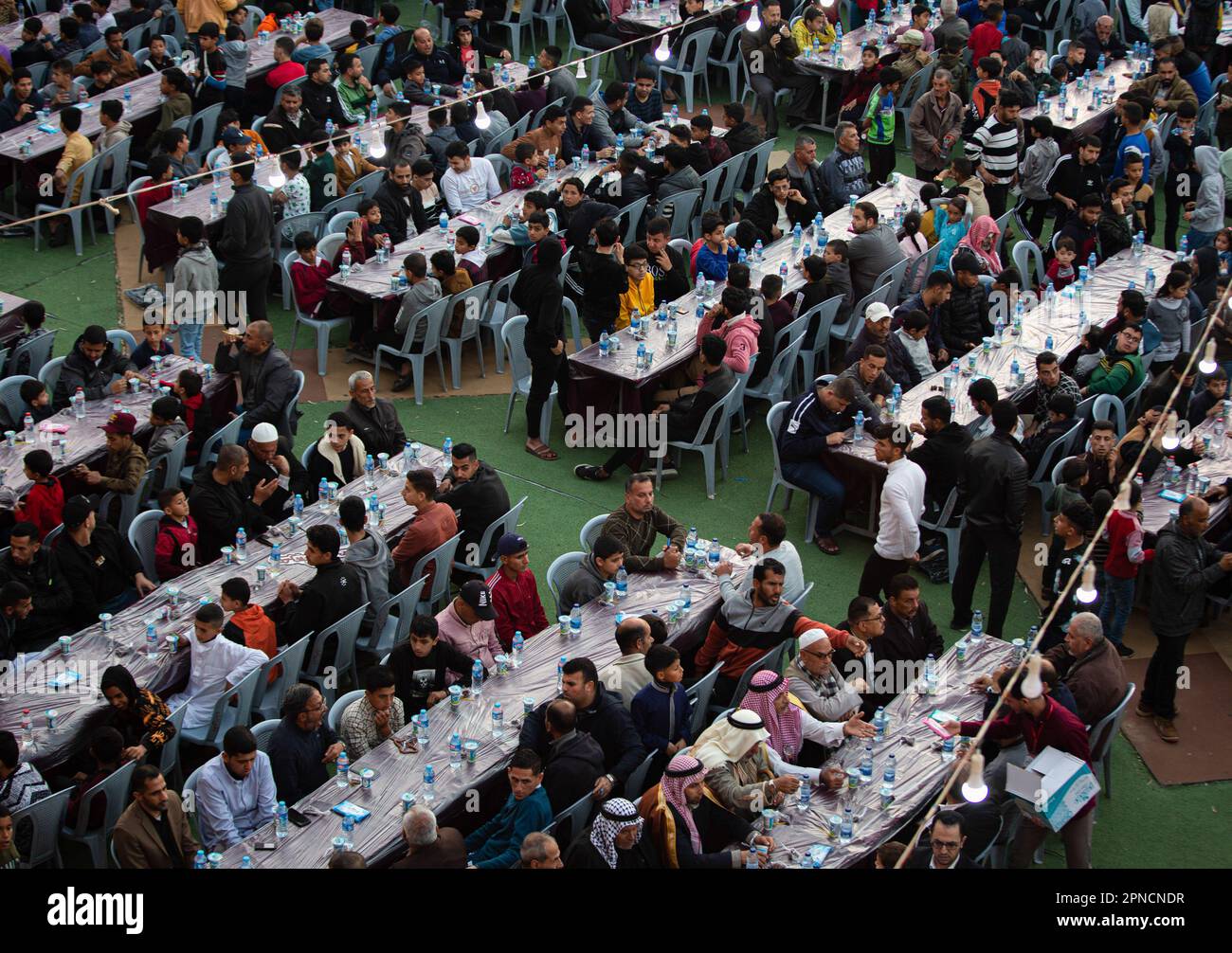 Gaza, Palestine. 17th Apr, 2023. Palestinian families eat a communal ...
