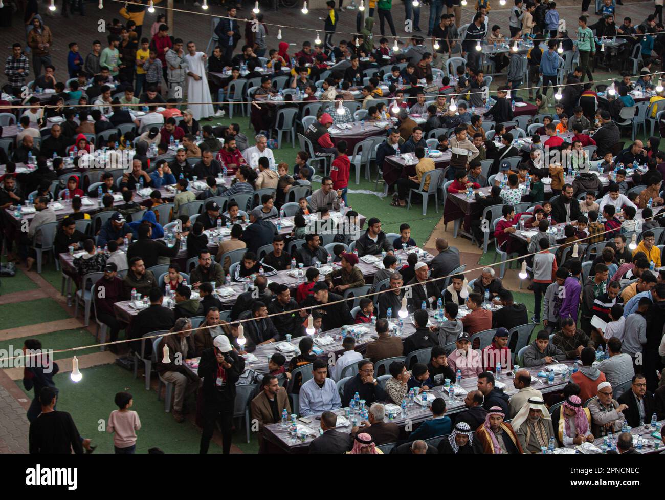 Gaza, Palestine. 17th Apr, 2023. Palestinian families eat a communal ...