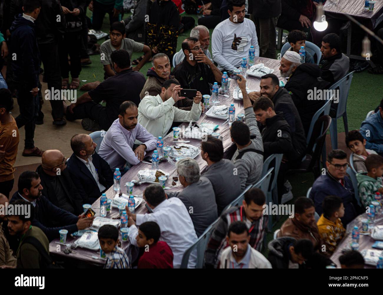 Gaza, Palestine. 17th Apr, 2023. Palestinian families eat a communal ...