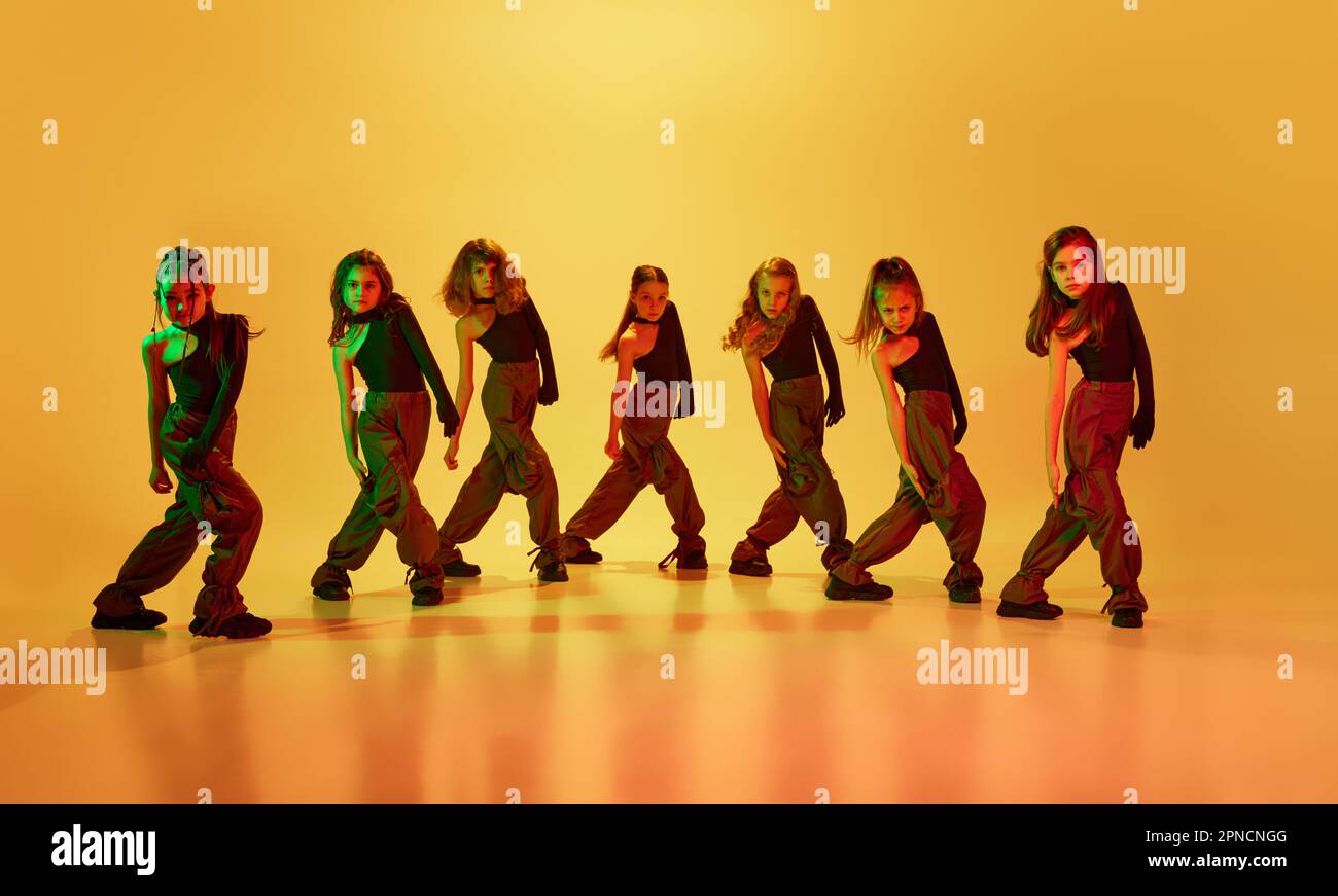 Little artistic girls, children in sport style clothes dancing hip-hop ...