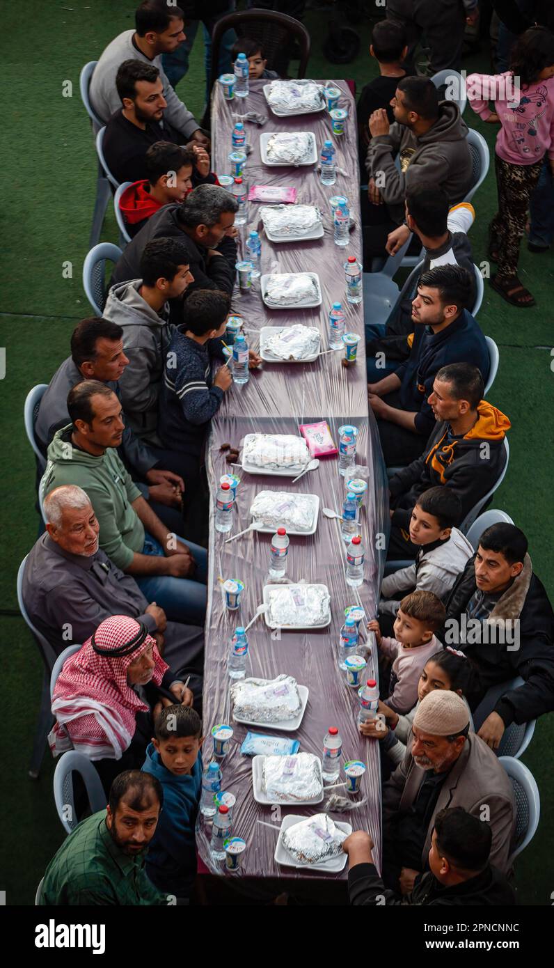 Gaza, Palestine. 17th Apr, 2023. Palestinian families eat a communal ...