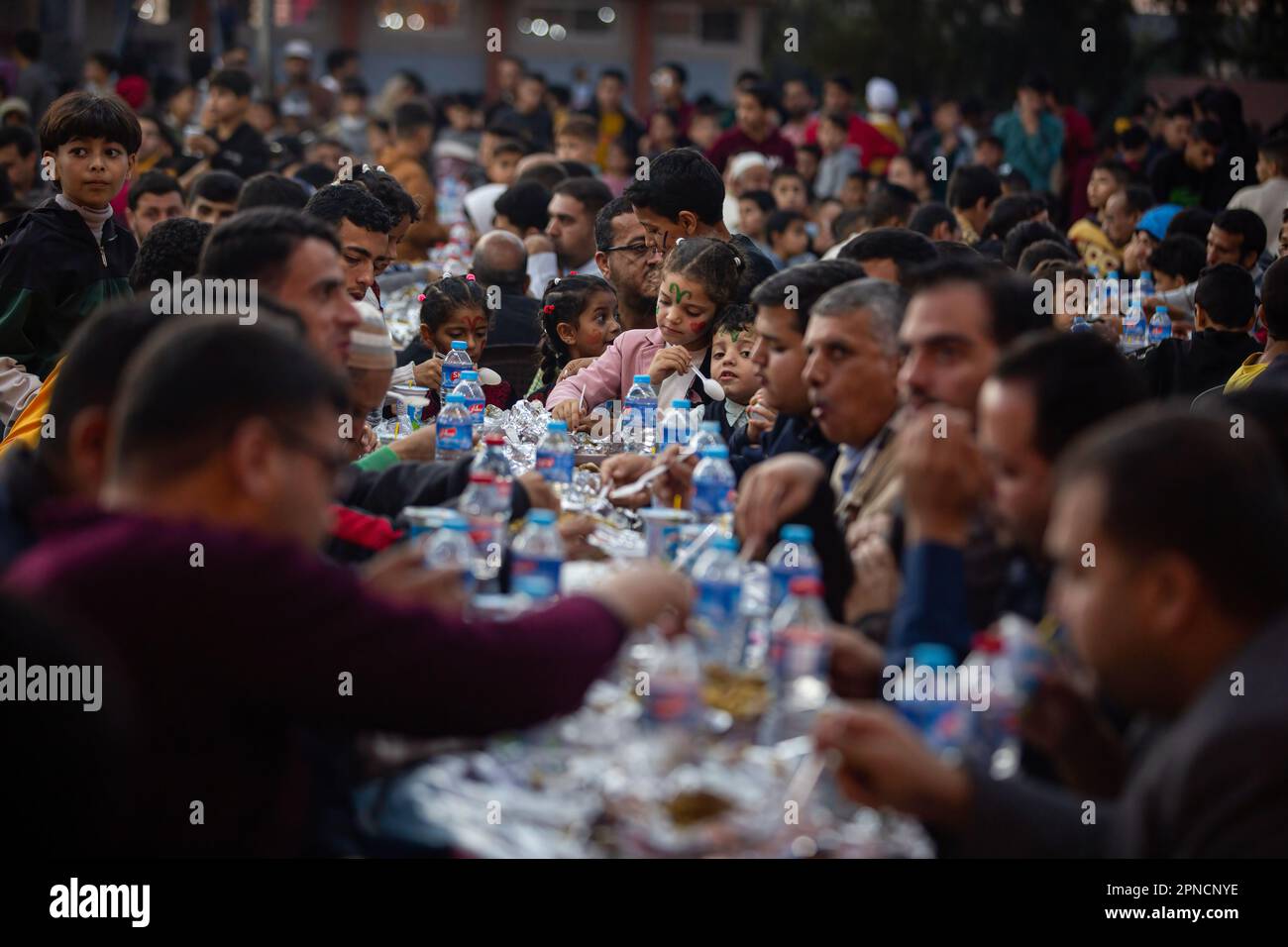 Gaza, Palestine. 17th Apr, 2023. Palestinian families eat a communal ...