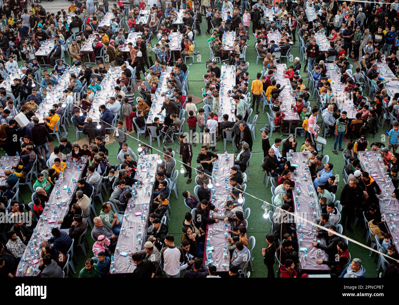 Gaza, Palestine. 17th Apr, 2023. Palestinian families eat a communal ...