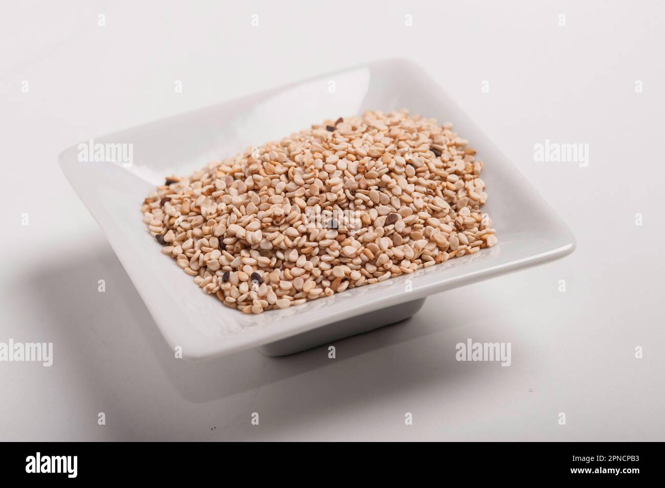 Sesame seeds on a white background Stock Photo - Alamy