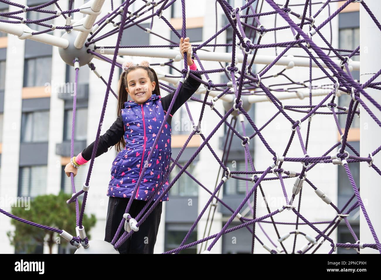 Cute teenage girl in the rope labyrinth kid park attraction Stock Photo ...