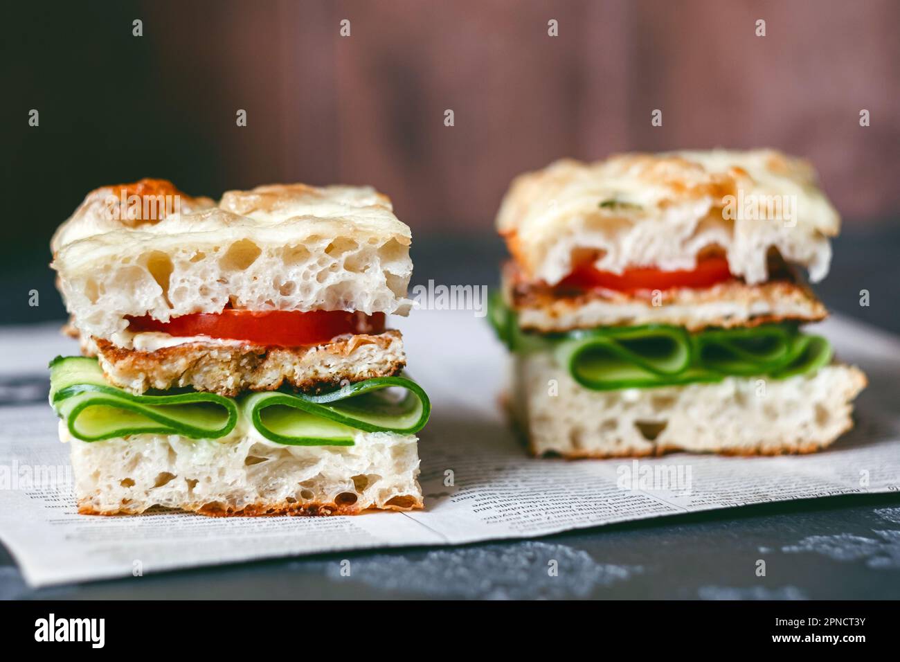 Homemade square burgers with grilled chicken and fresh vegetables in a ...