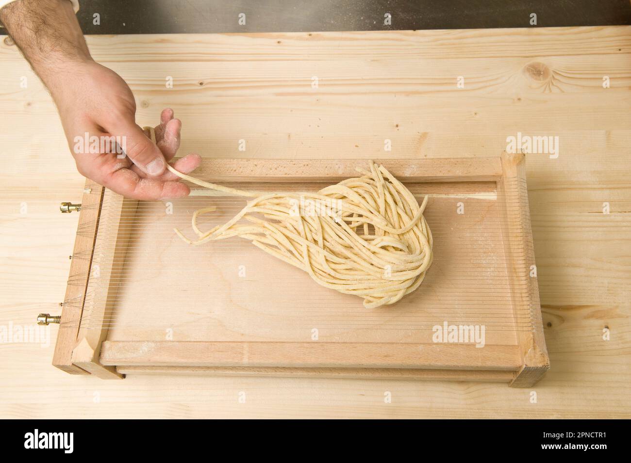 Making Spaghetti alla Chitarra from fresh pasta by hand. Italy Stock ...