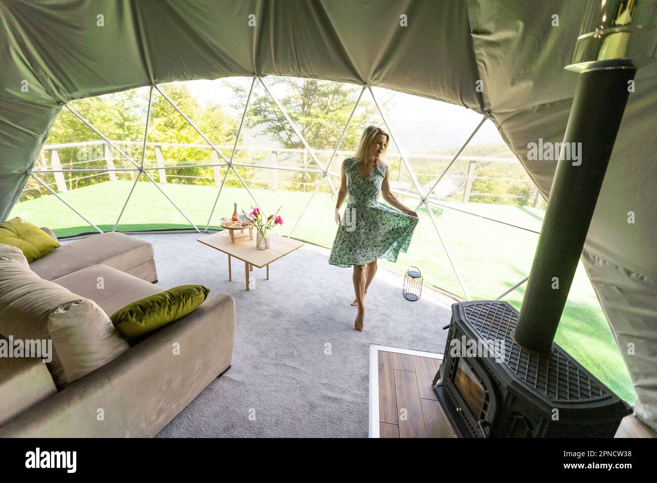 a woman enjoys solitude inside of a transparent bubble hotel Stock ...