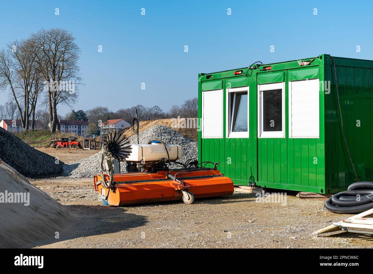 Tow hitch with rotating brushes for street cleaning at a construction ...