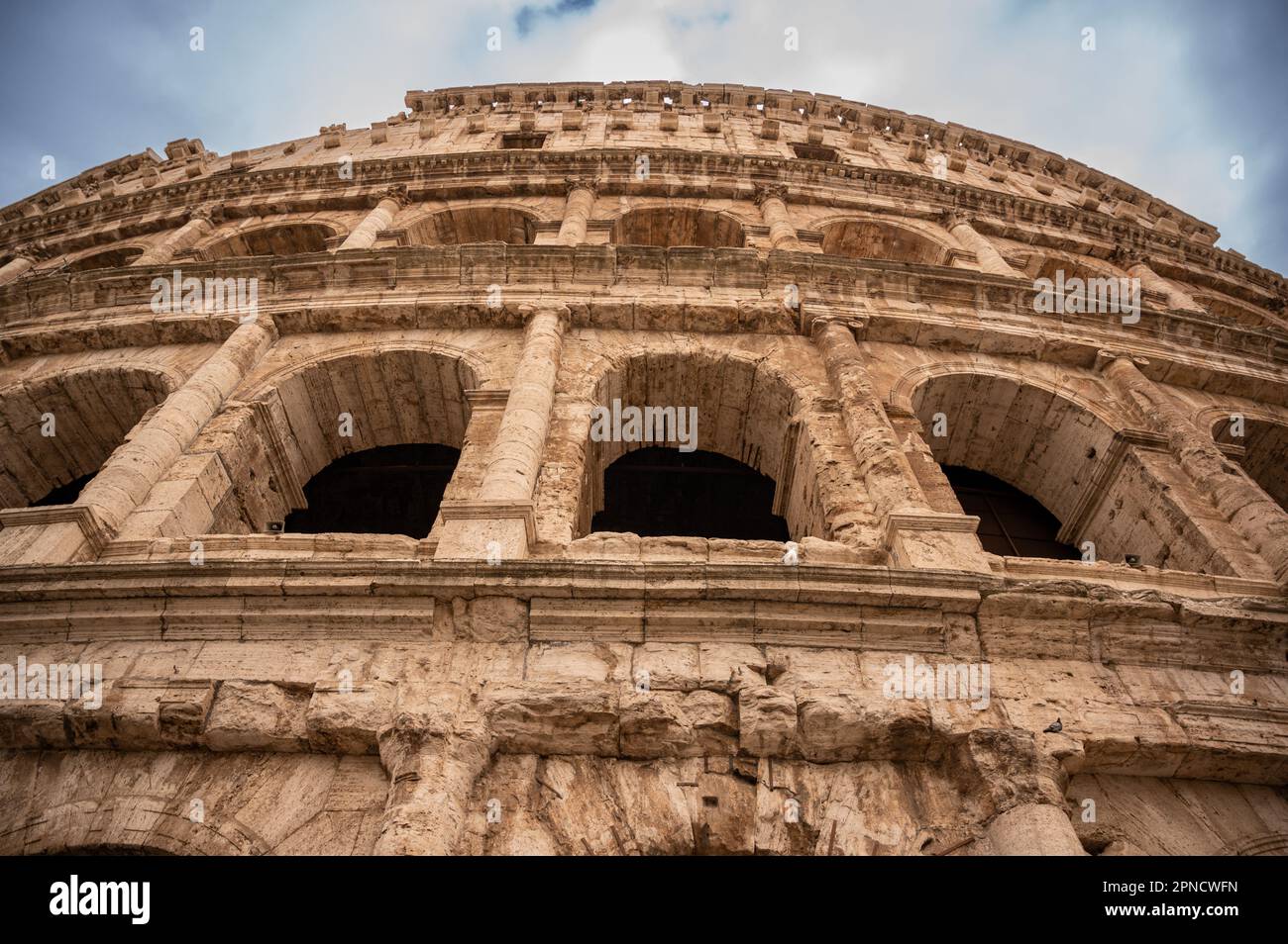A side view of the ancient Roman Colosseum, located in the center of ...