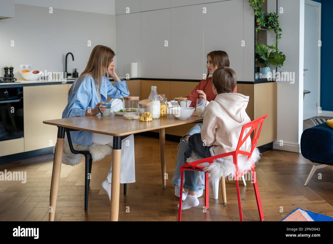 Caring mom have breakfast with children siblings. Morning family talk ...