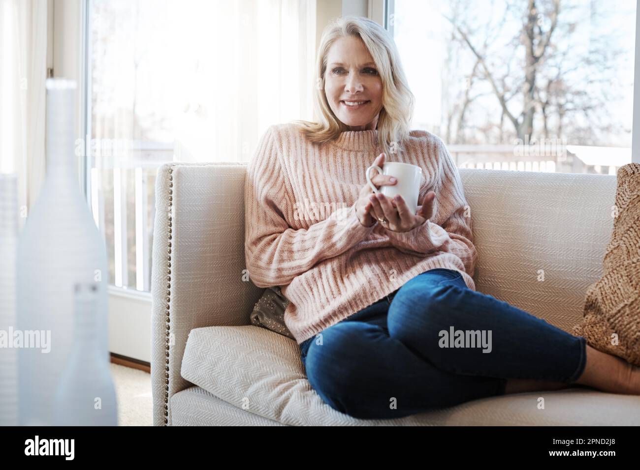 Its your time. Rest yourself. a mature woman relaxing on the sofa at ...