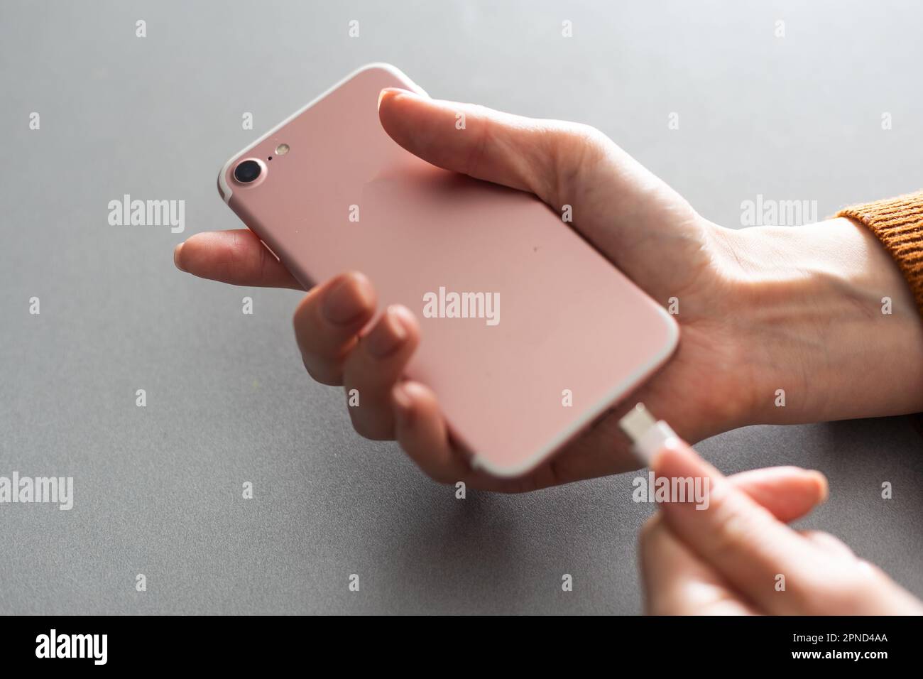 Plugging charger into mobile telephone hi-res stock photography and ...