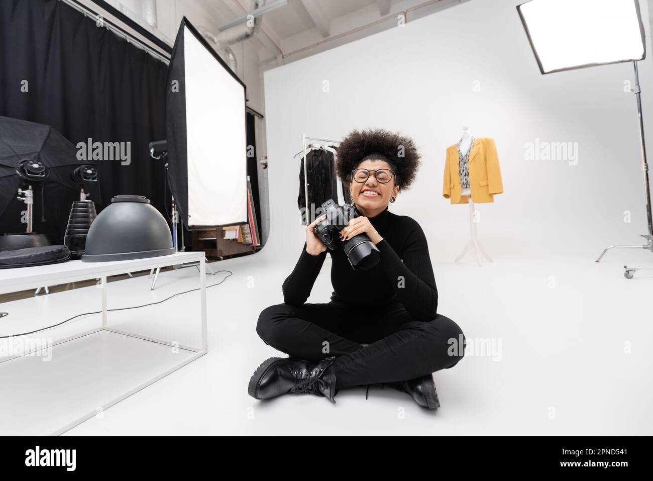 overjoyed african american content producer with digital camera sitting ...