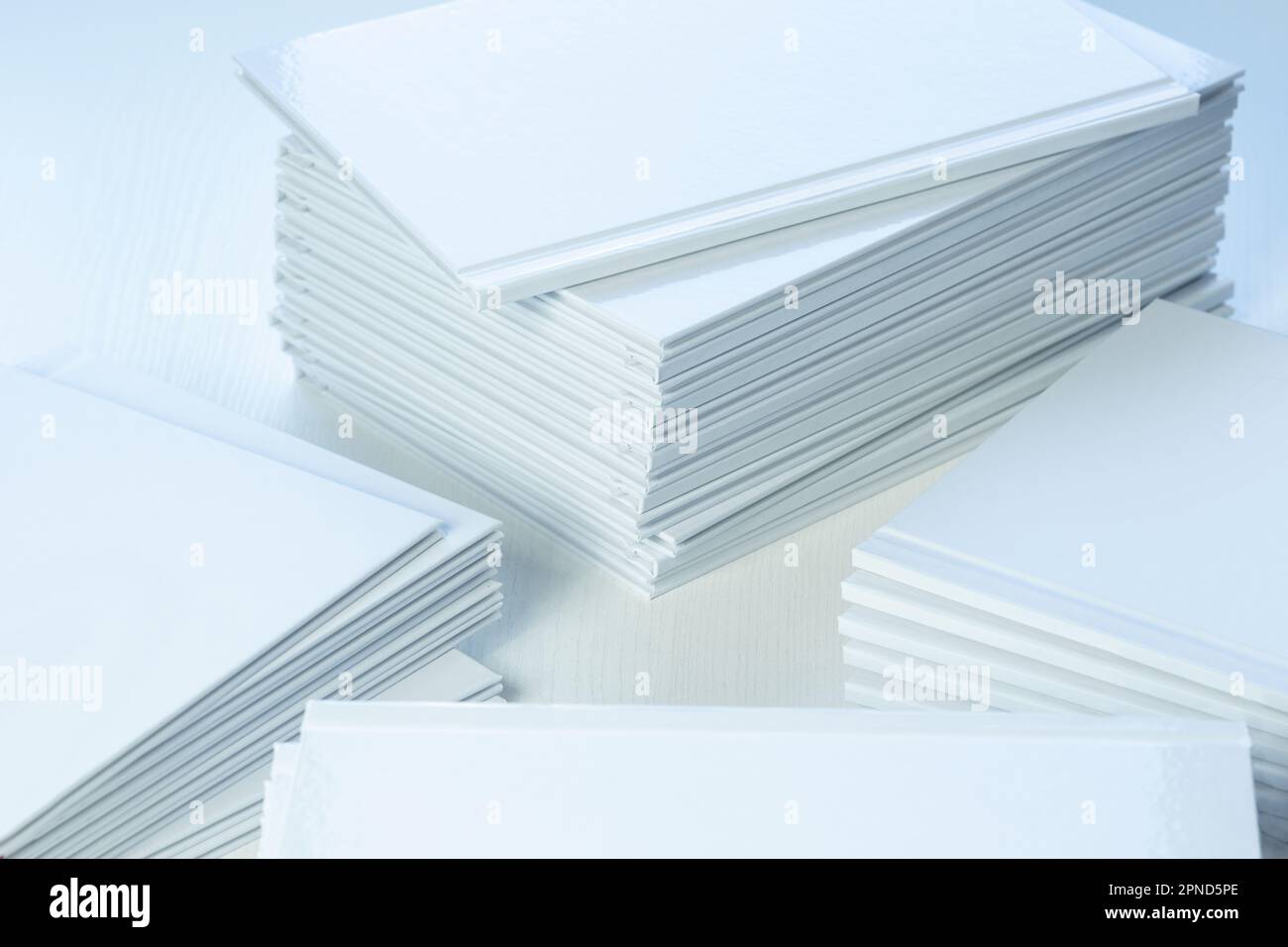 stacks of freshly printed photobooks with clean empty white covers ...