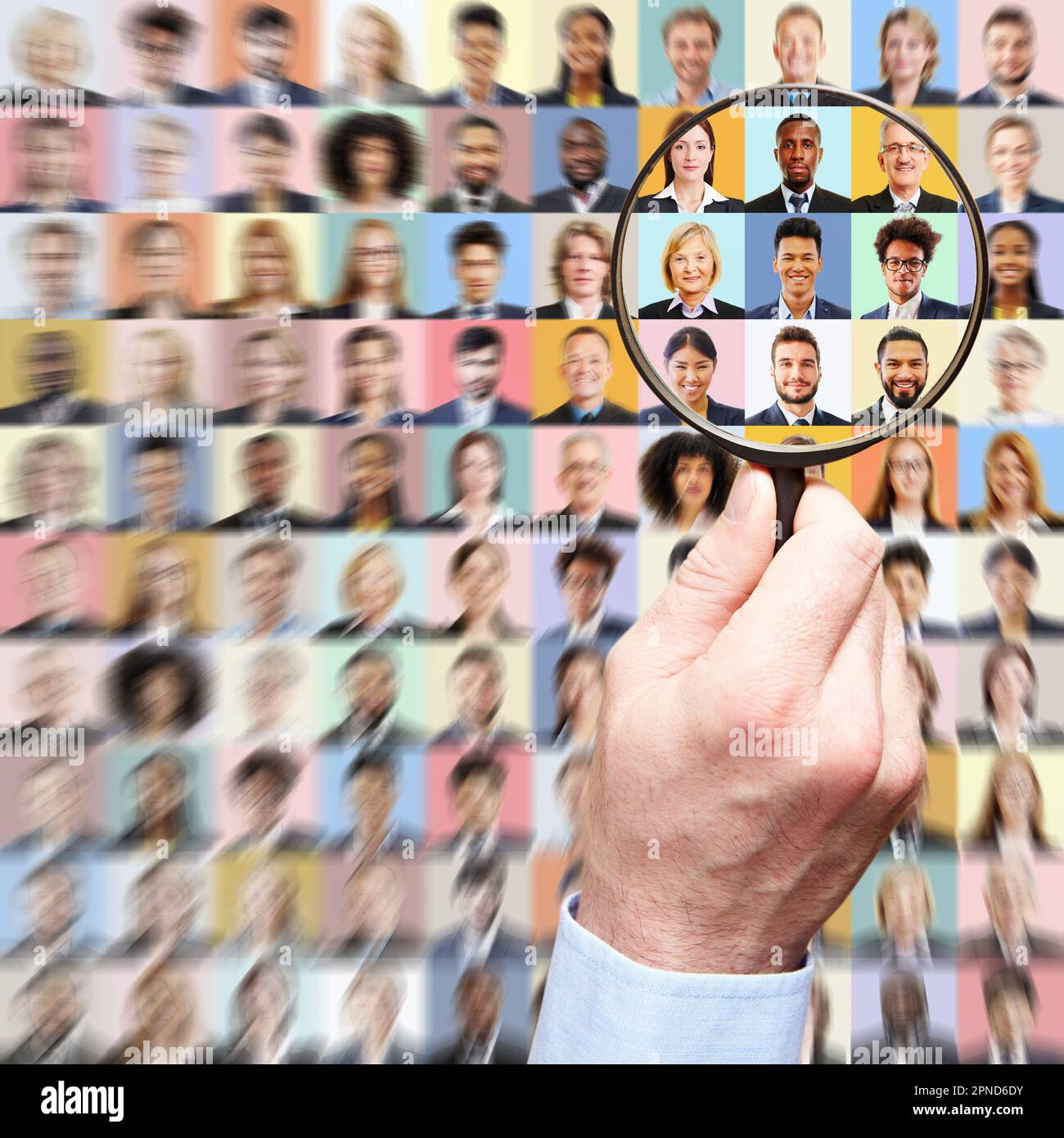 Hand with magnifying glass searches suitable candidate under Portrait ...