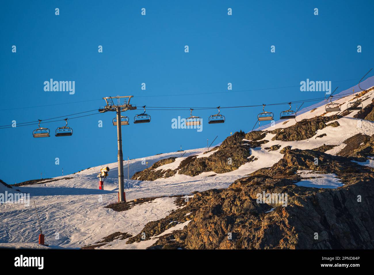 Huez, France - 9 April 2023: Ski lift during sunset on mountain slope ...