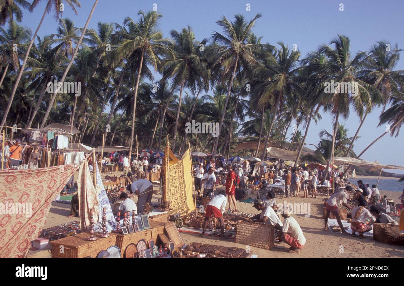 Shops and Tourists at the old style Anjuna Flea market on the Coast at ...