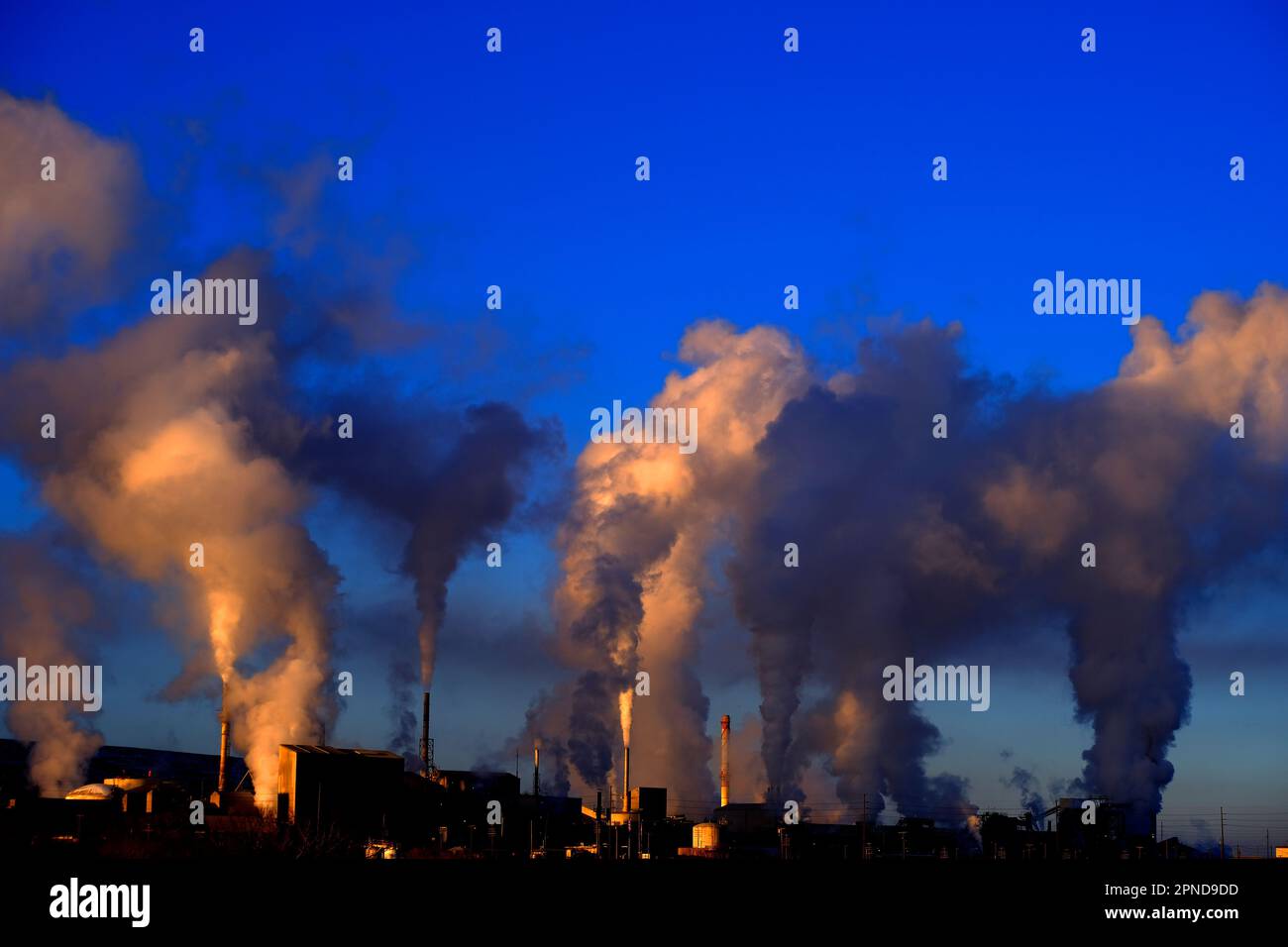 Factory chimneys spewing pollution into the sky smoke rising pollutants ...
