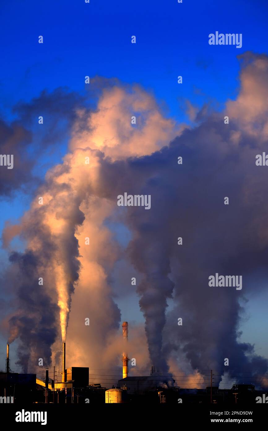 Factory chimneys spewing pollution into the sky smoke rising pollutants ...