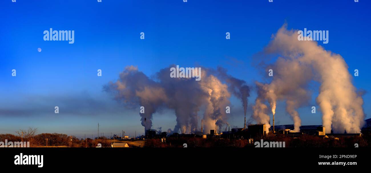 Factory chimneys spewing pollution into the sky smoke rising pollutants ...